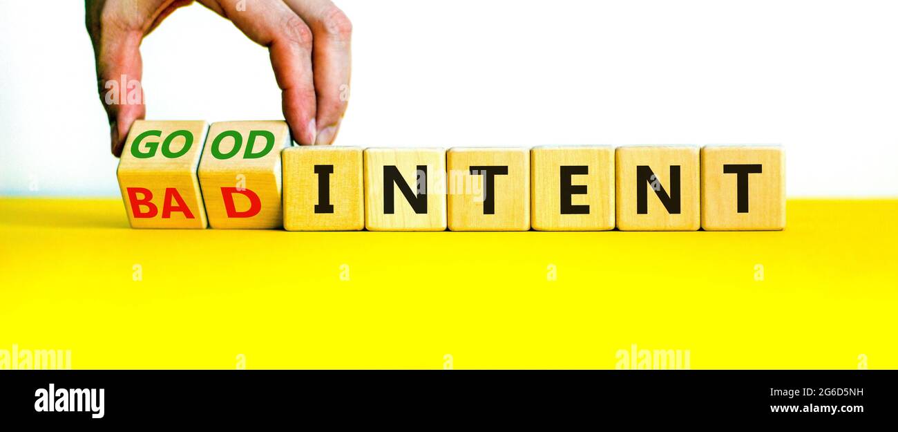 Good or bad intent symbol. Businessman turns wooden cubes and changes ...