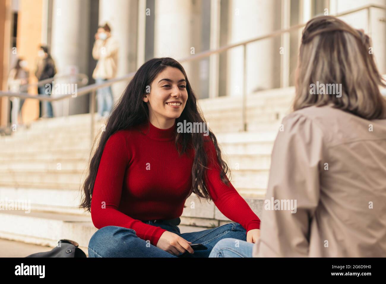 Two girls sitting on stairs hi-res stock photography and images - Alamy