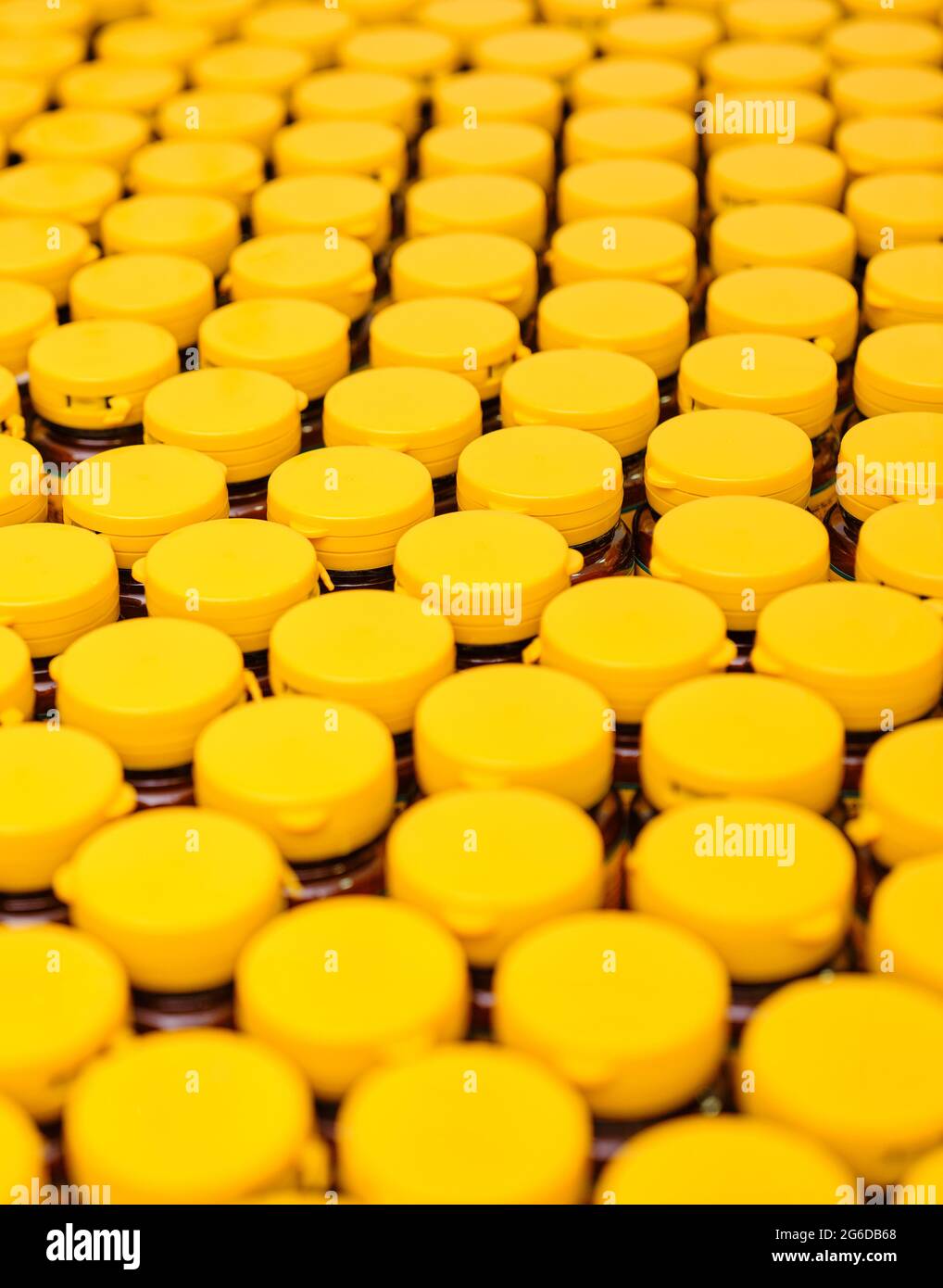 Full frame background of bottles with yellow caps and liquid medicine ...