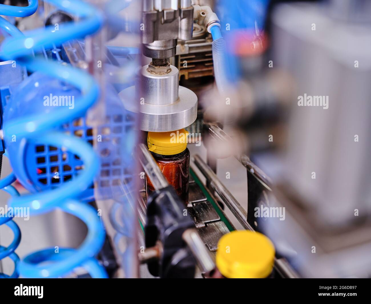 From above of modern pharmaceutical machine capping plastic bottles ...