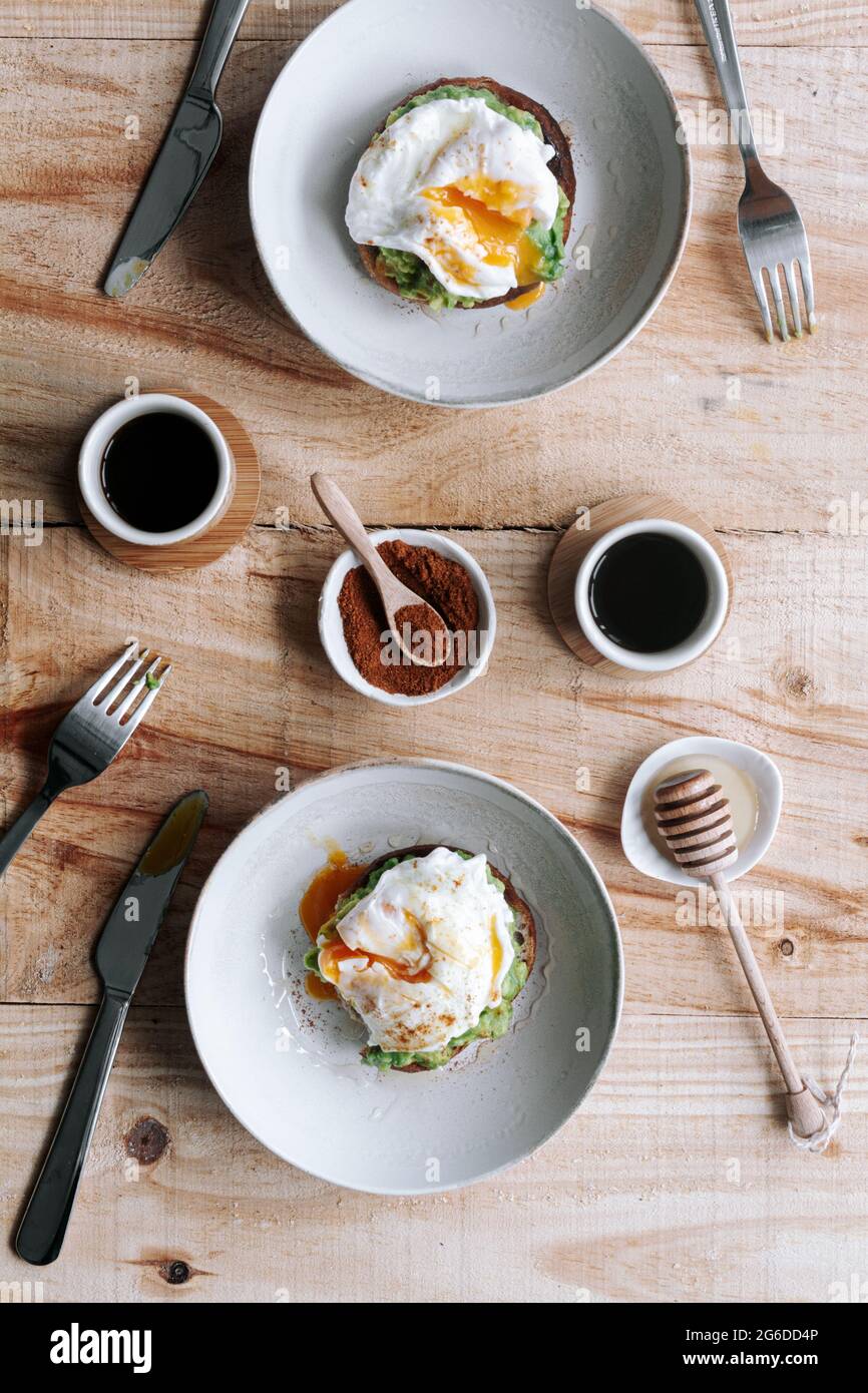 Appetizing slice of grain bread with avocado and poached egg on top ...
