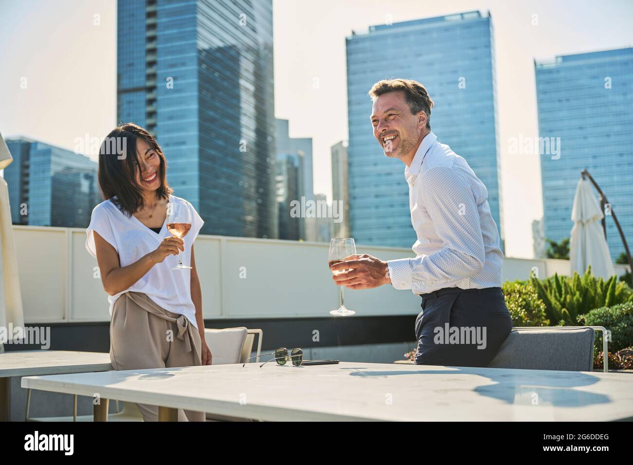 Designer and workmate after work having relaxing time in a terrace next ...