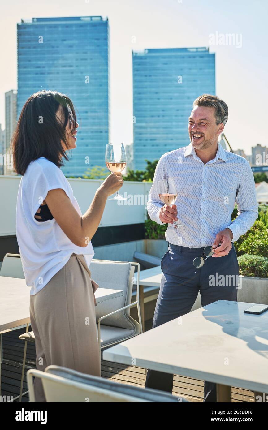 Designer and workmate after work having relaxing time in a terrace next ...