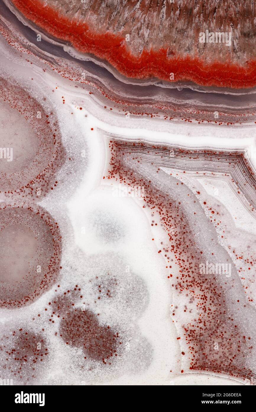 Macro of abstract background of agate gemstone with white and red spots ...