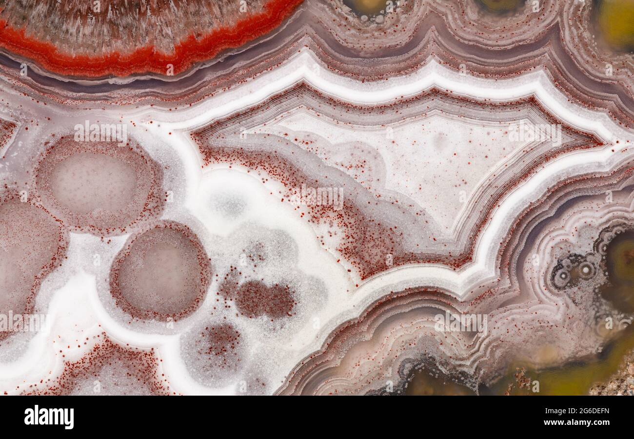 Macro of abstract background of agate gemstone with white and red spots ...