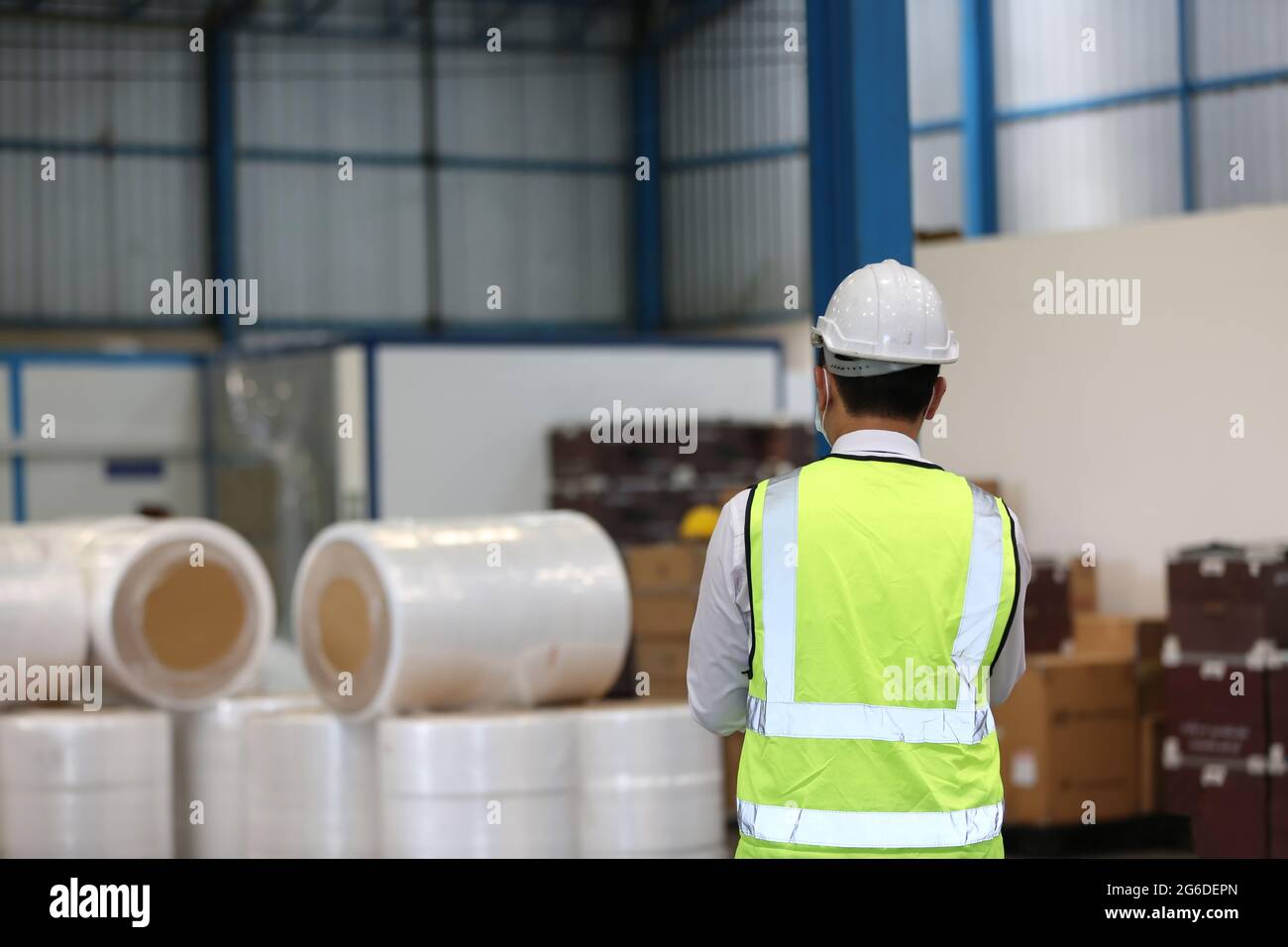 Warehouse worker man with safety hard hat is checking order details ...