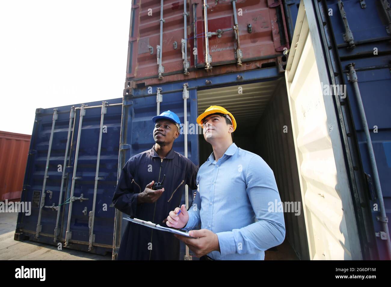 Foreman control loading Containers box from Cargo freight ship for ...