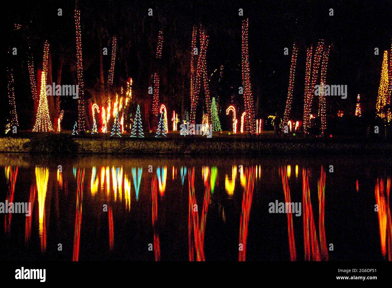Christmas light display reflection in pond water Stock Photo - Alamy