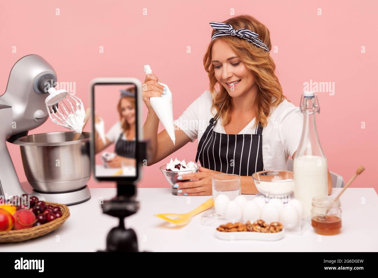 Portrait of concentrated food vlogger showing process of decoration ...