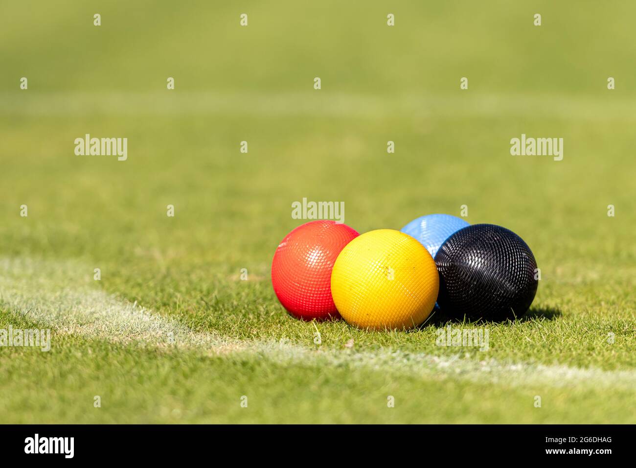 a set of colorful croquet balls on the green lawn before the game Stock ...