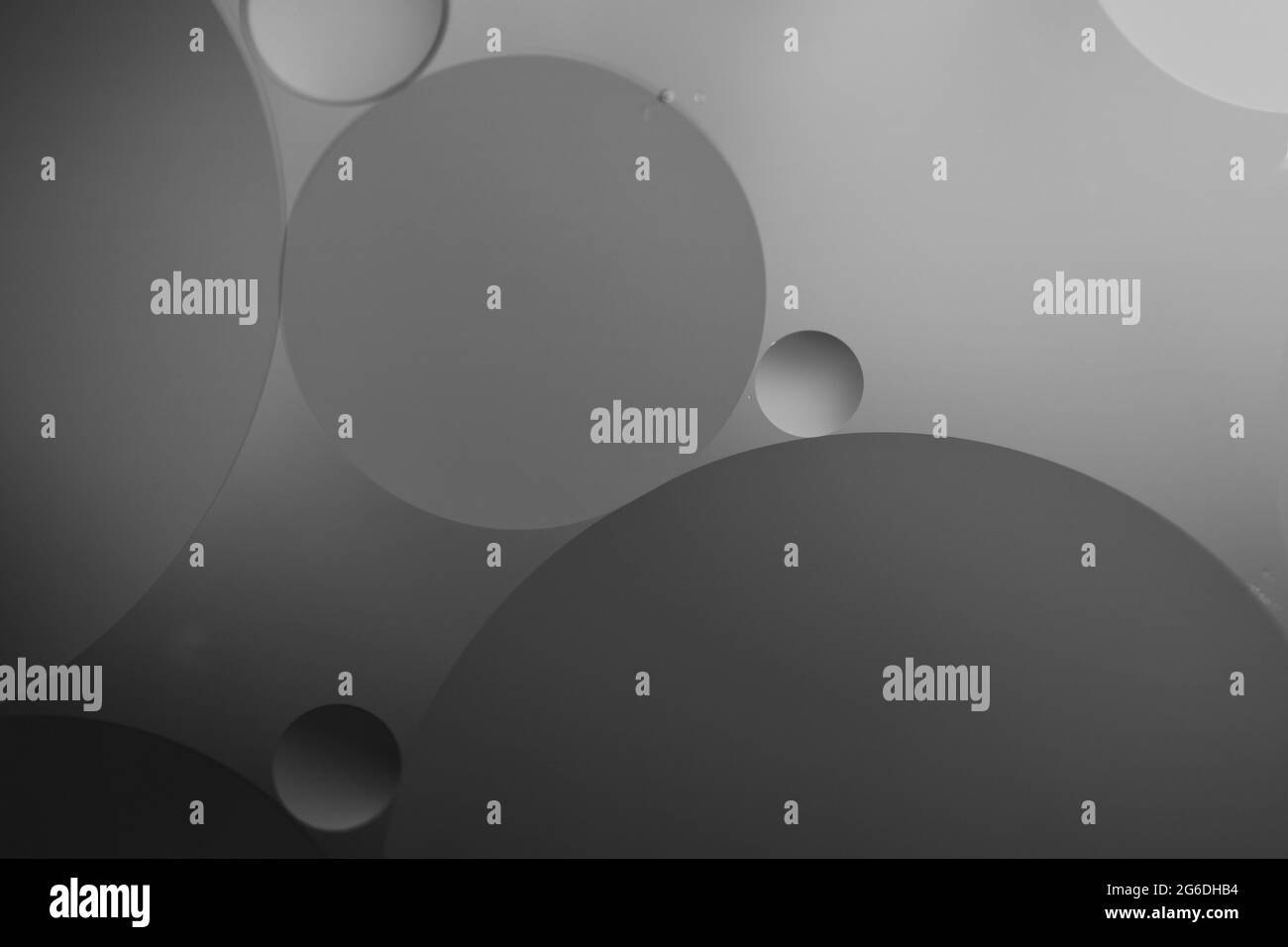 A grayscale black-and-white image of bubbles formed by oil in water ...