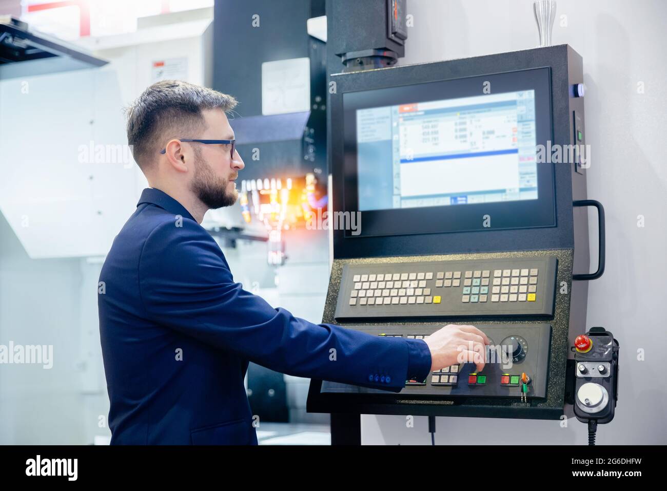 Maintenance engineer control automatic CNC machine in smart factory for ...