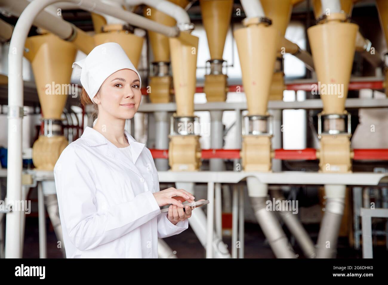 Operator worker woman on background electrical mill machinery for ...