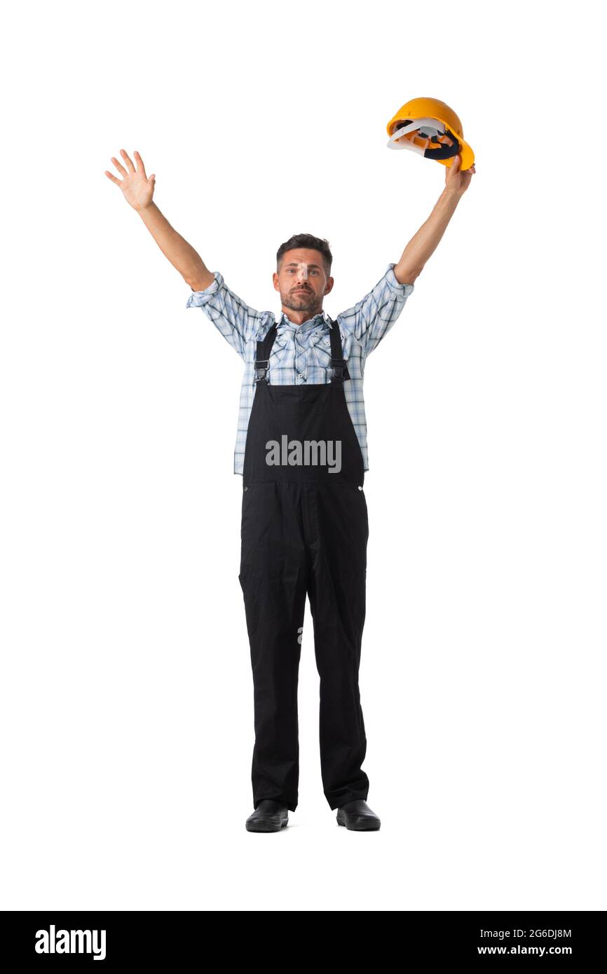Full length of manual worker with hands raised isolated on white ...