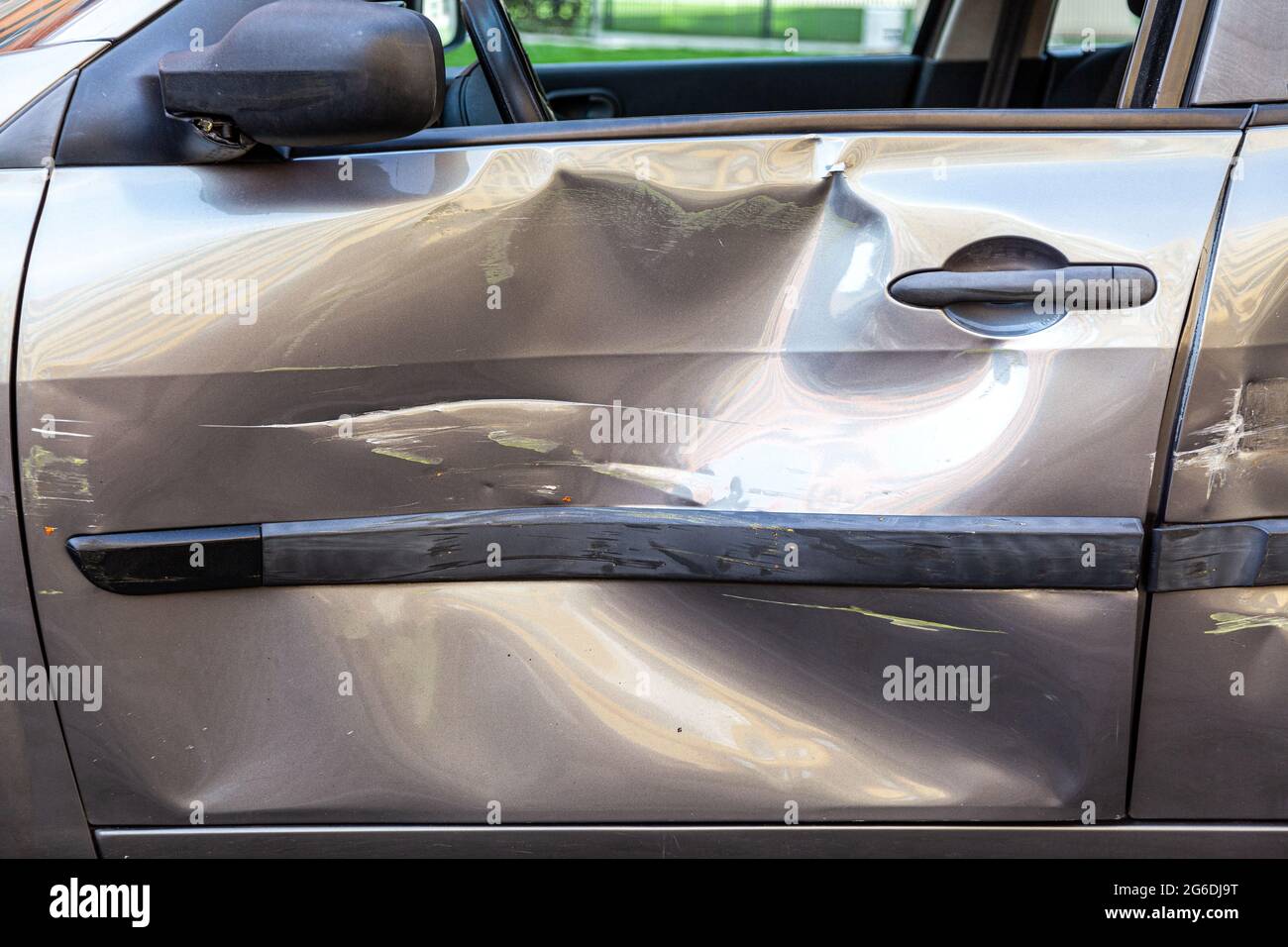 Side view of destroyed car after crash, closeup of dents and scratches ...