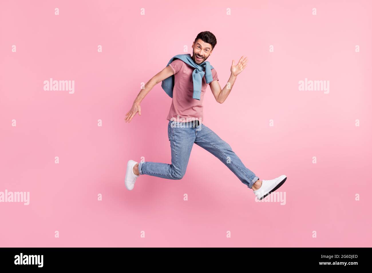 Full size photo of happy cheerful smiling handsome man running in air ...