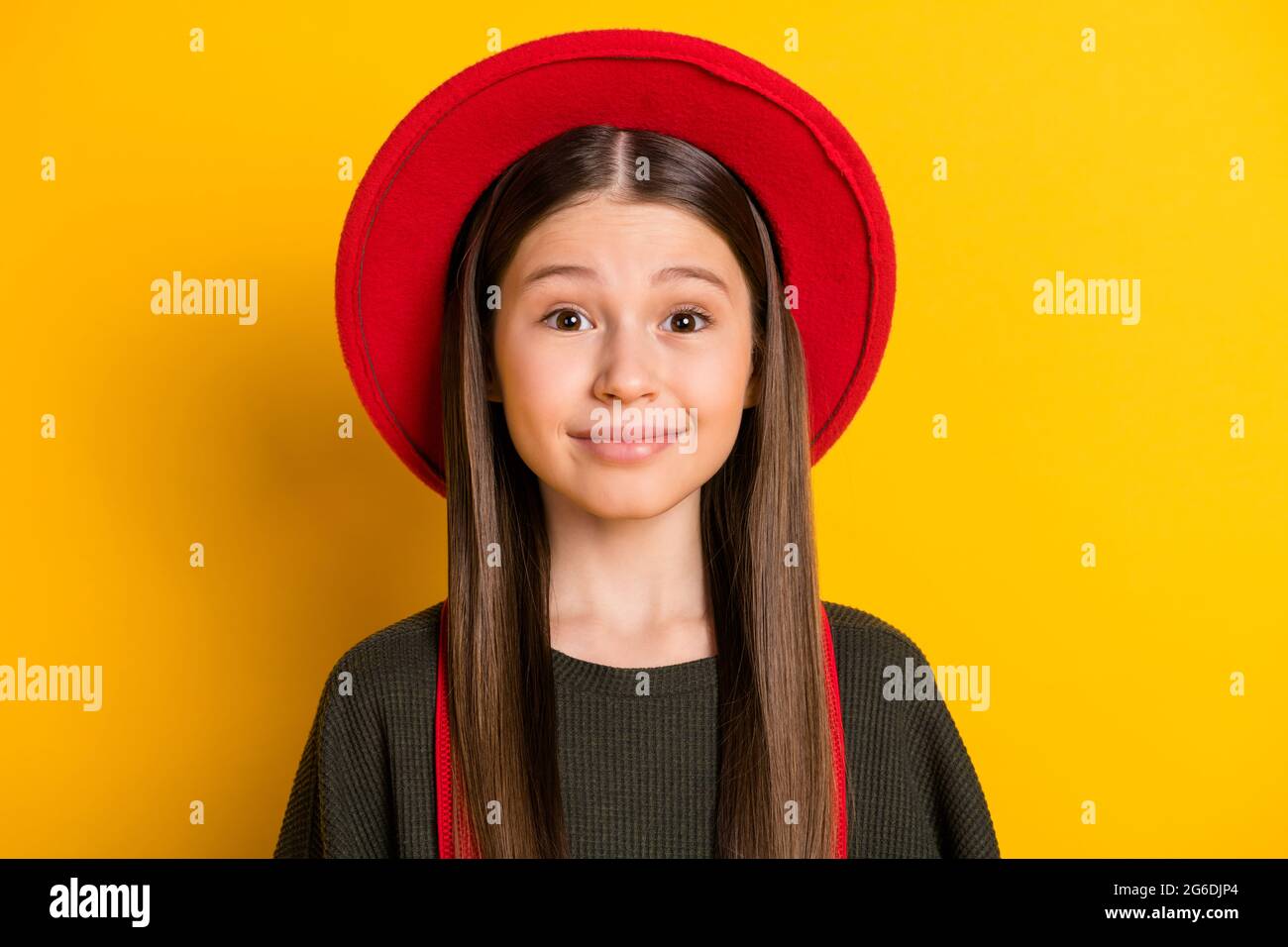 Photo portrait of smiling schoolgirl wearing red hat isolated on bright ...
