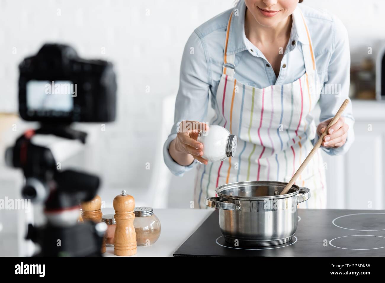 Woman adding salt to food hi-res stock photography and images - Alamy