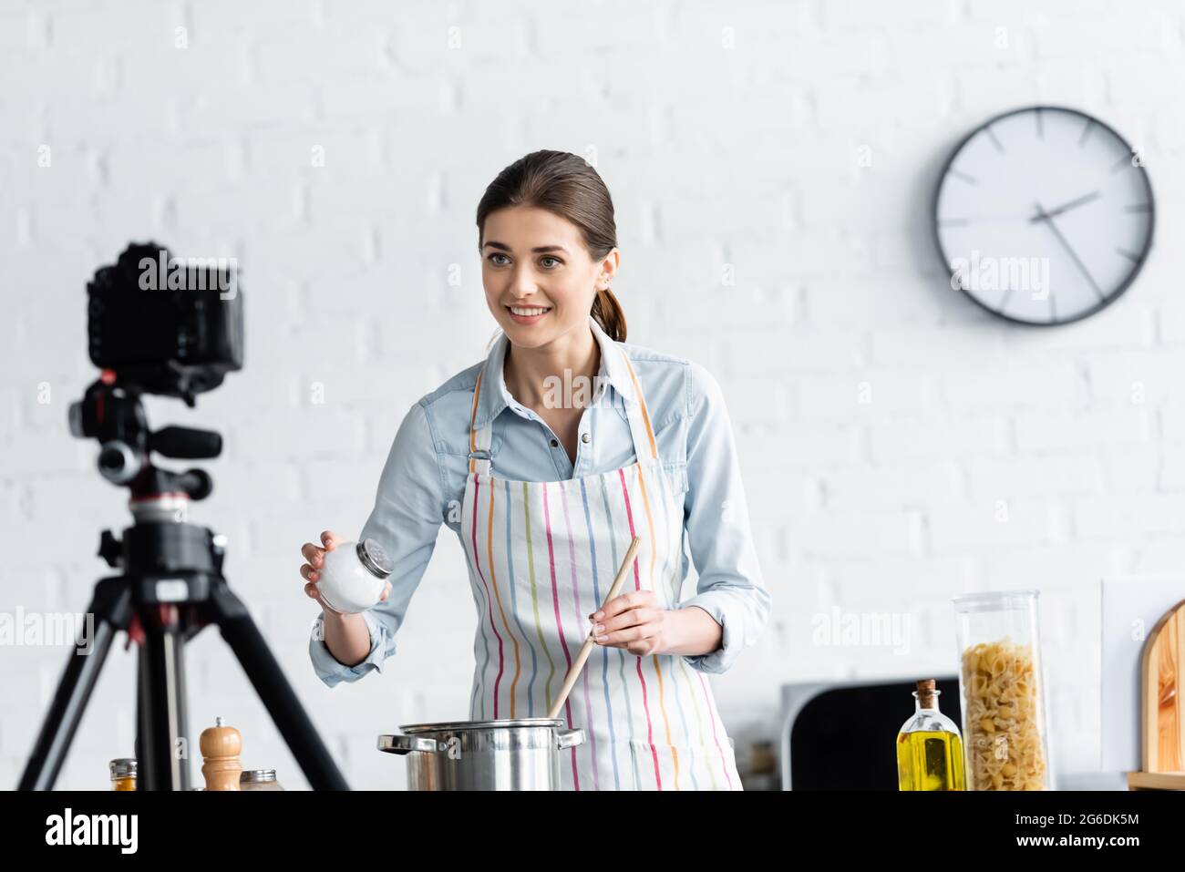 Woman adding salt to food hi-res stock photography and images - Alamy
