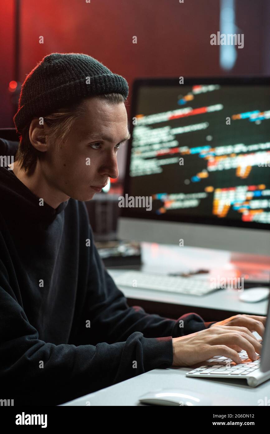 Serious young male hacker concentrating at work Stock Photo - Alamy