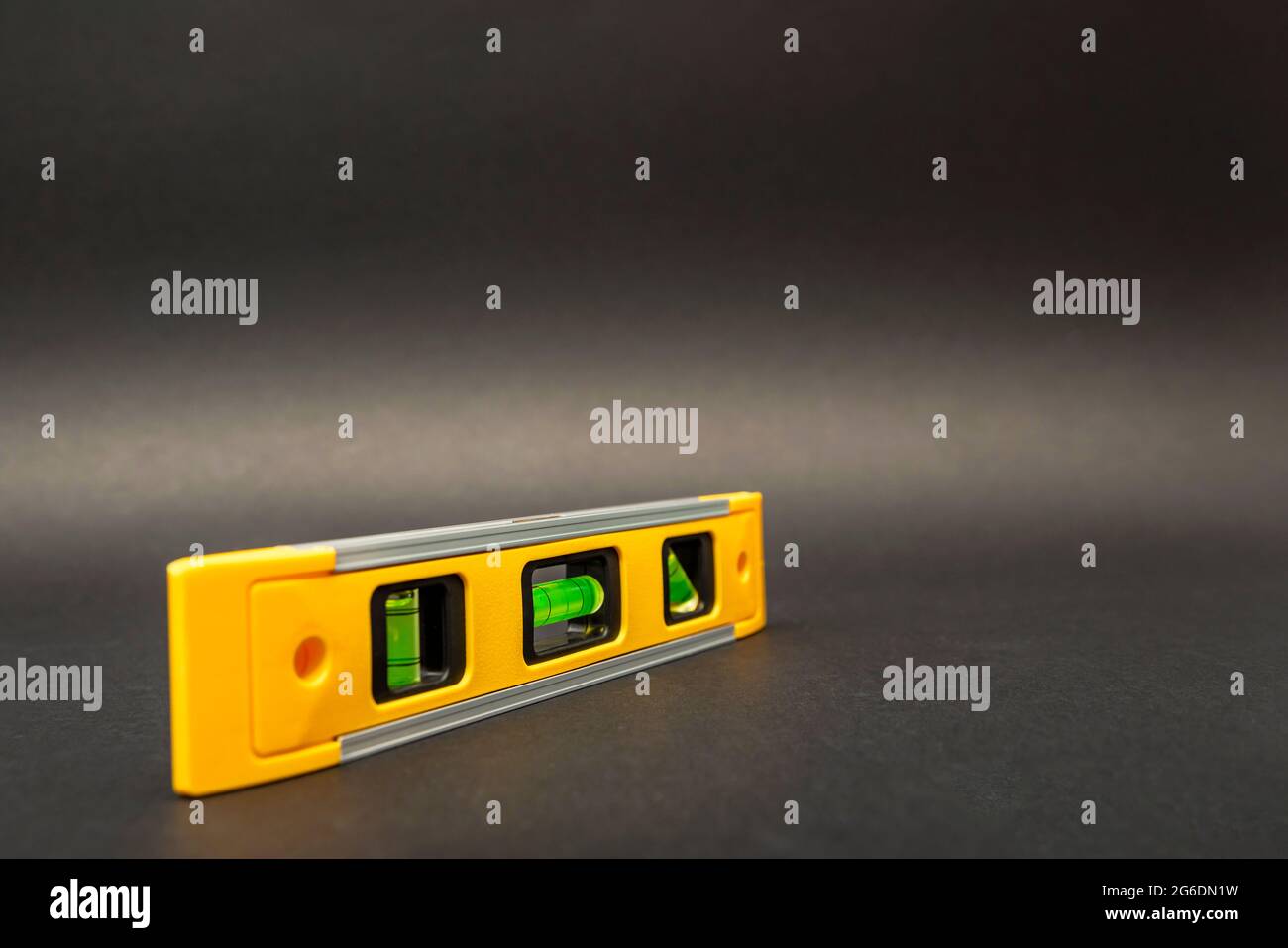 Building level in yellow on a black background. Construction tool ...