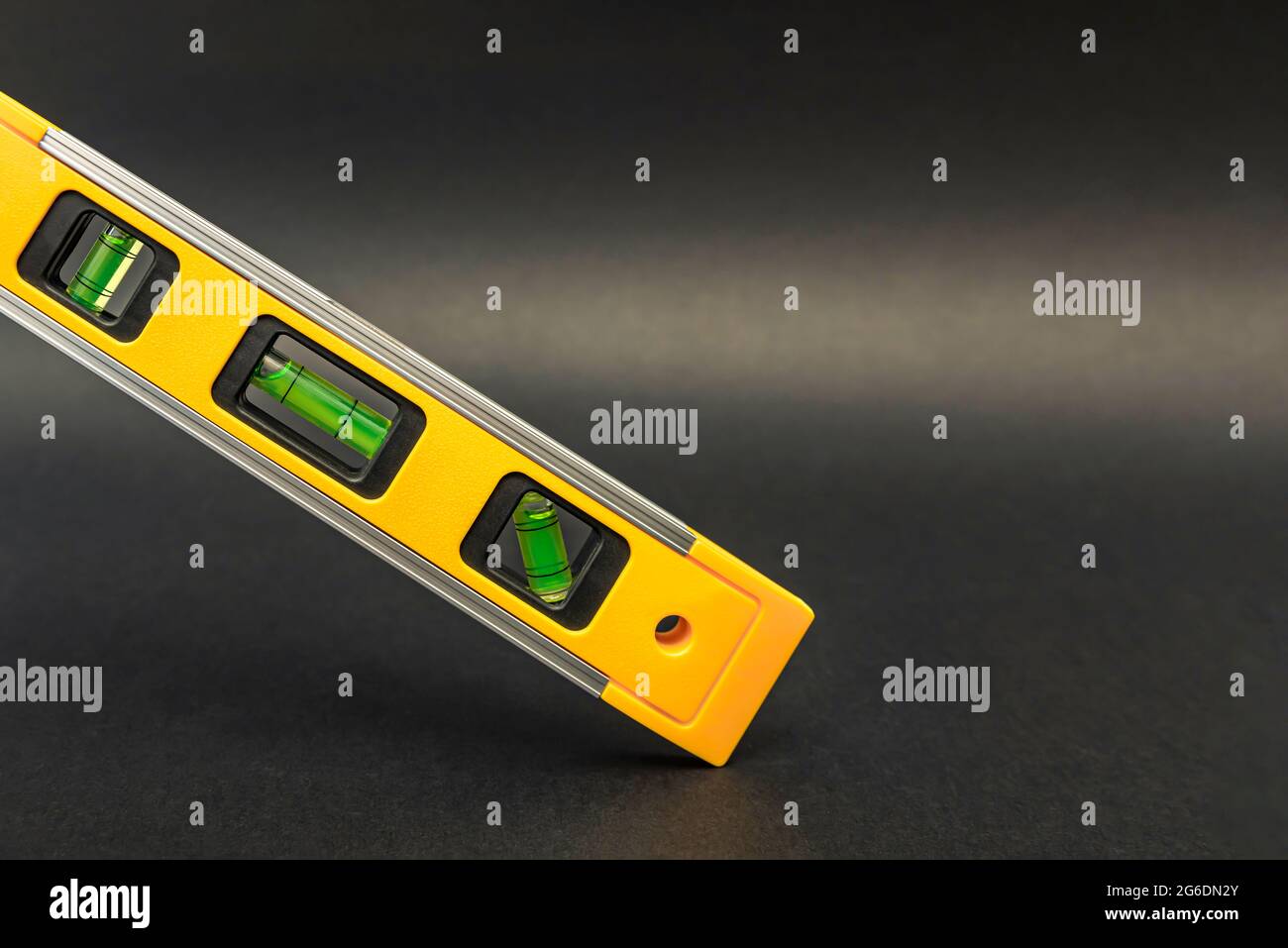 Building level in yellow on a black background. Construction tool ...