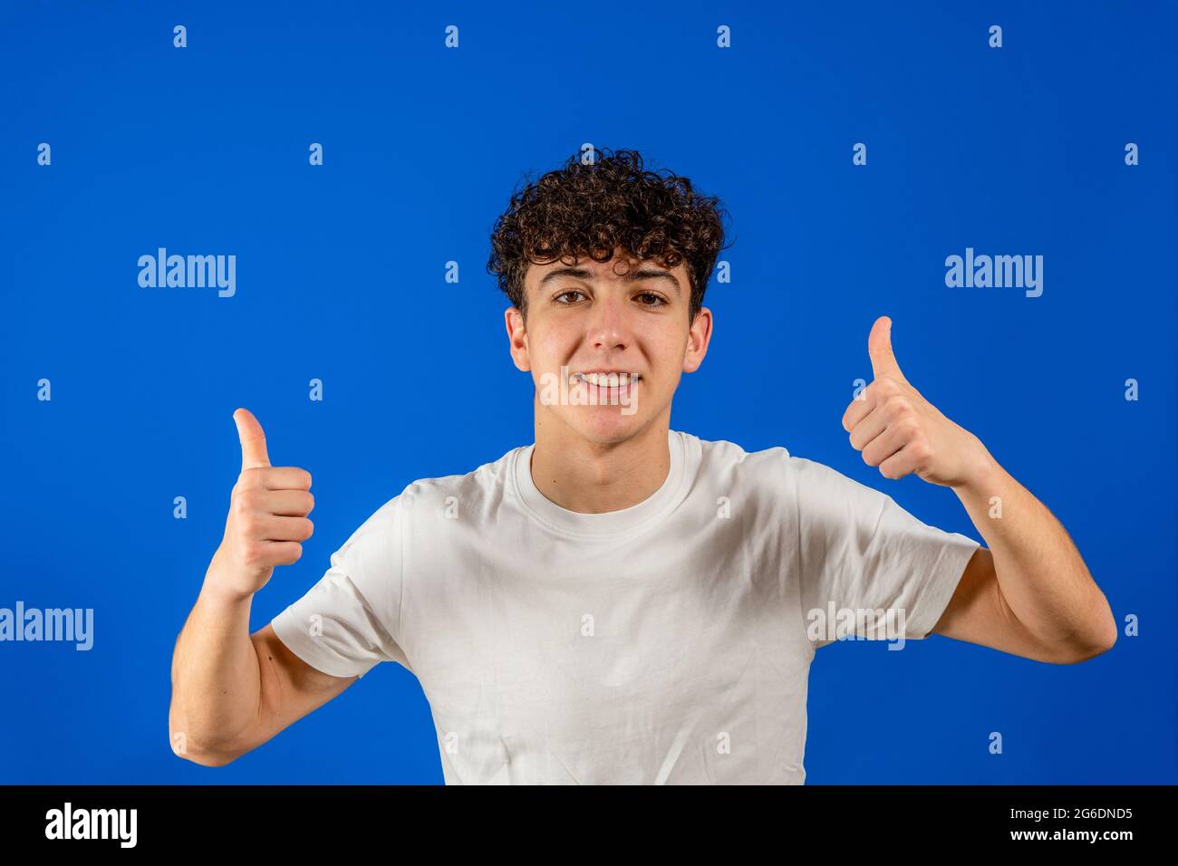 Handsome hispanic model man over isolated blue background doing happy ...