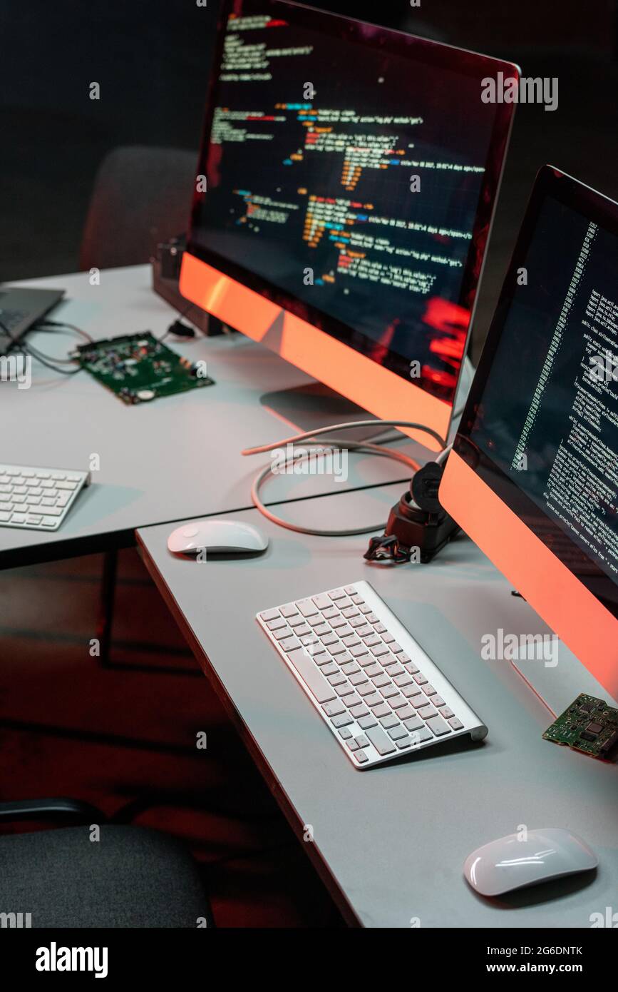 Two computer monitors with coded data on screens Stock Photo - Alamy