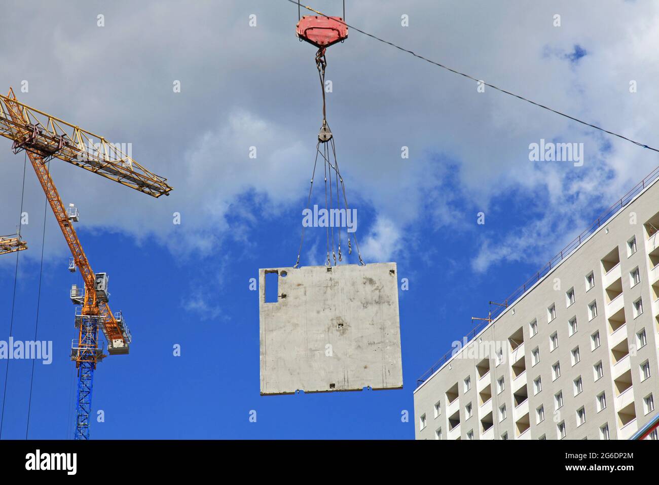 Construction. Construction site. Reinforced concrete slab lifted by a ...