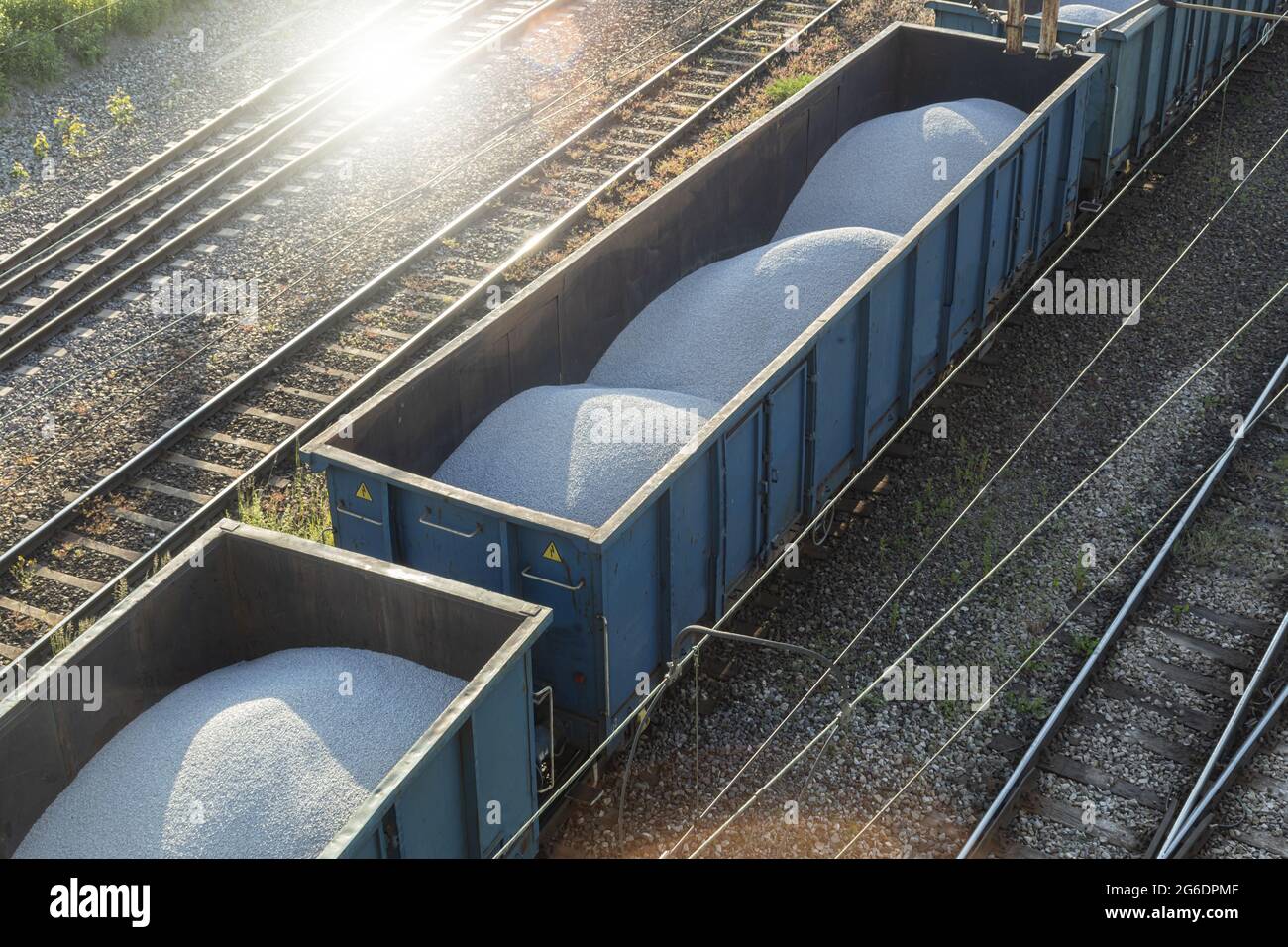 Loaded railway carriages travel on rails. Freight train with white ...