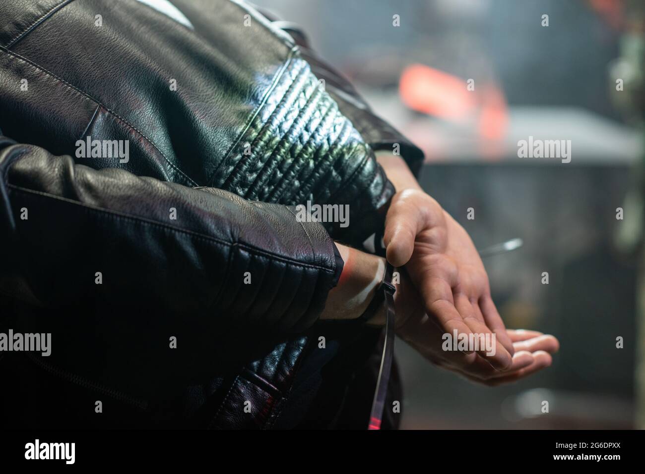 Hands in cuffs and back of captured criminal in black leather jacket ...