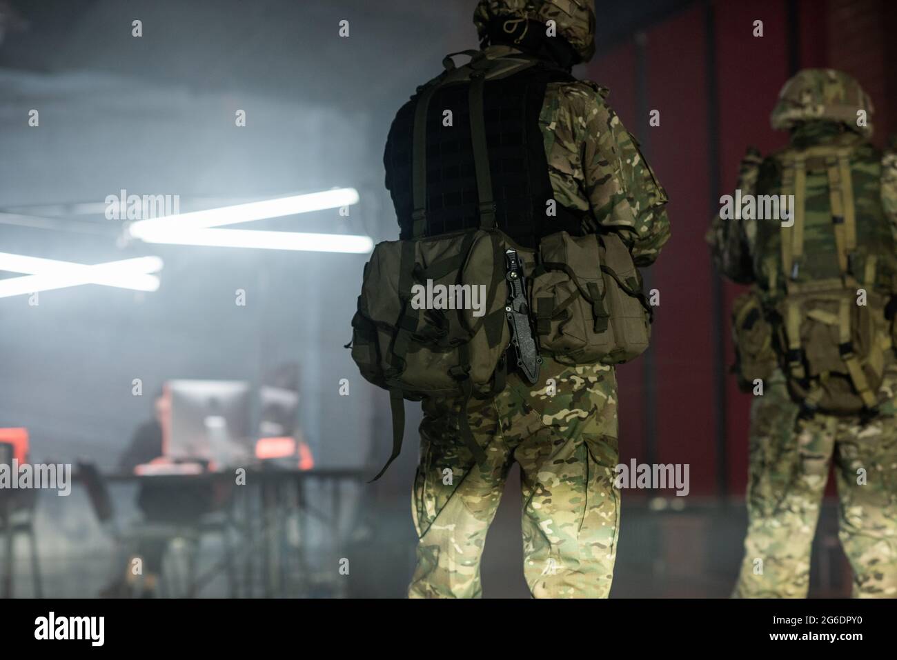 Rear view of two men in military uniform moving towards office Stock ...