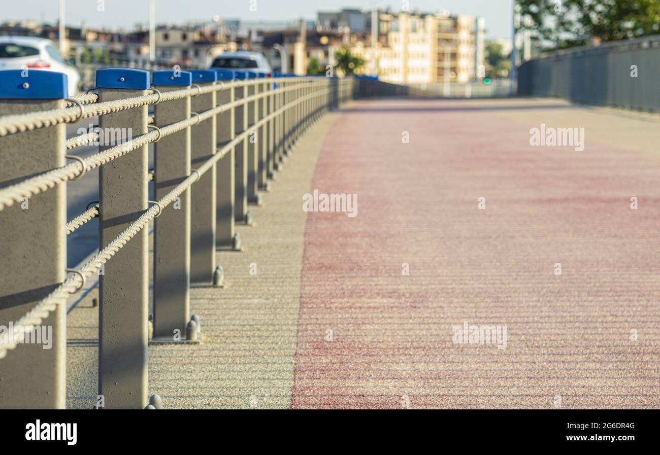 The running track is fenced off from the carriageway. Fencing by ...
