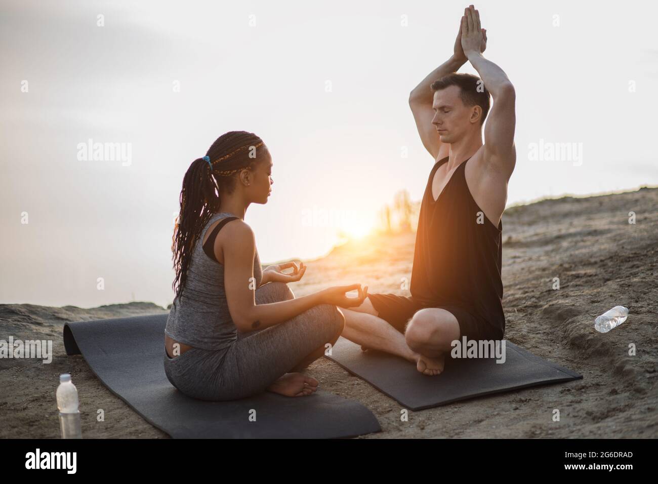 Multicultural couple meditating closed eyes hi-res stock photography ...