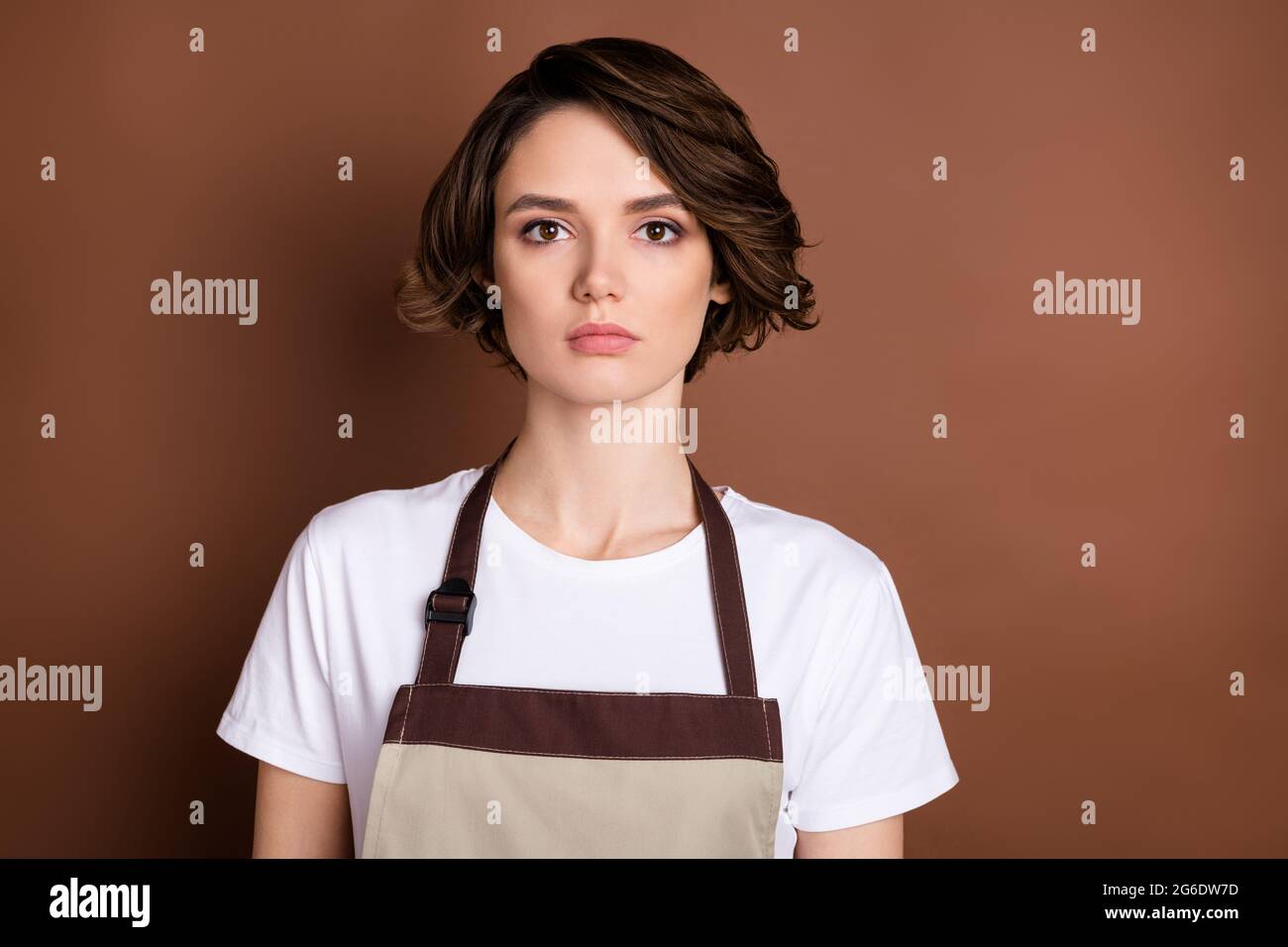 Portrait of charming concentrated person look camera no emotions face ...