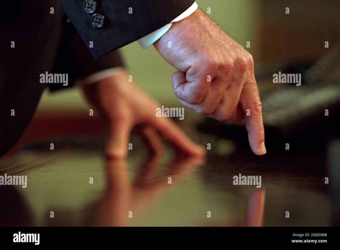 Tapping on the desk hewn from the timbers of the H.M.S. Resolute ...