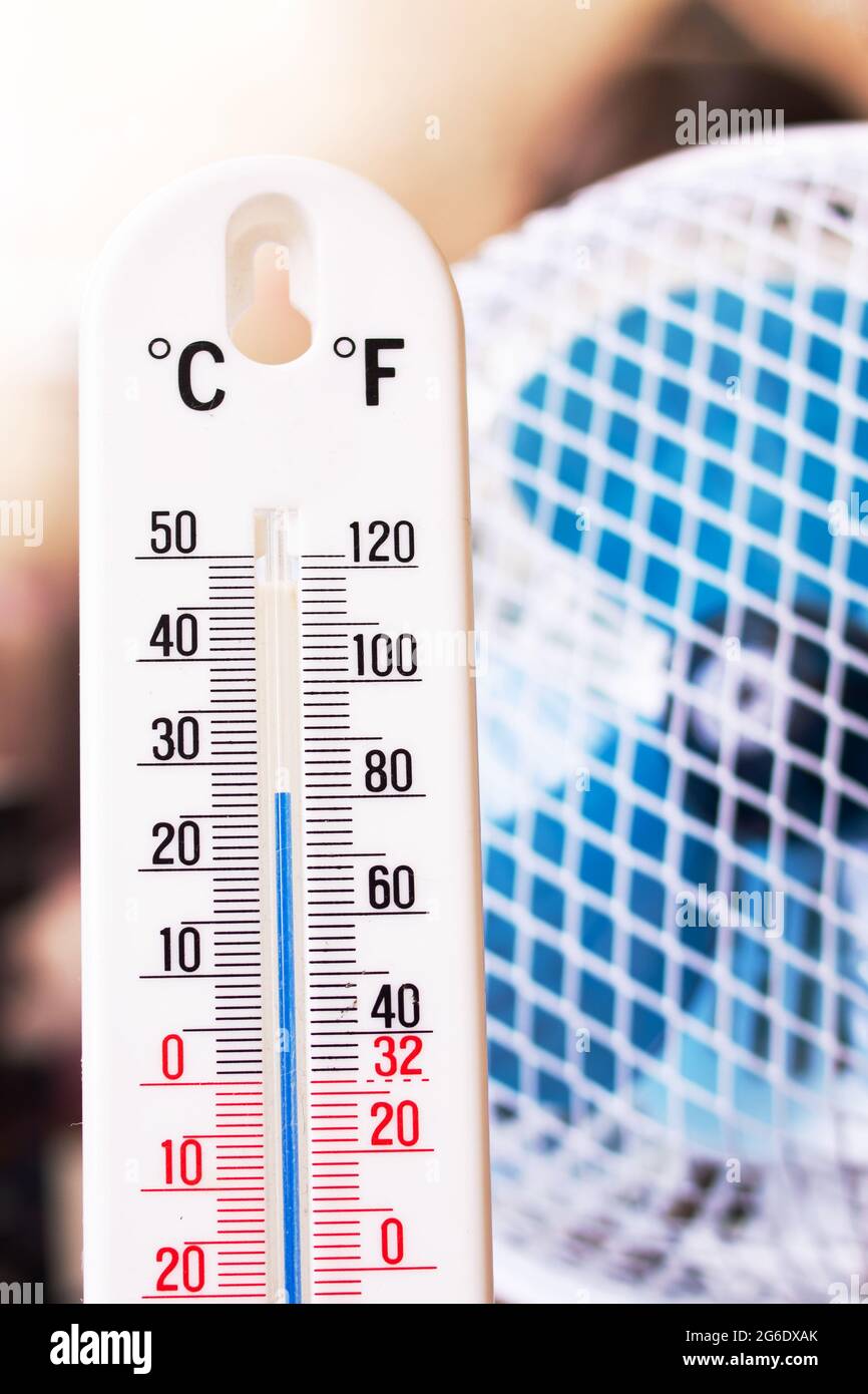 Small fan and room mercury thermometer close up Stock Photo - Alamy