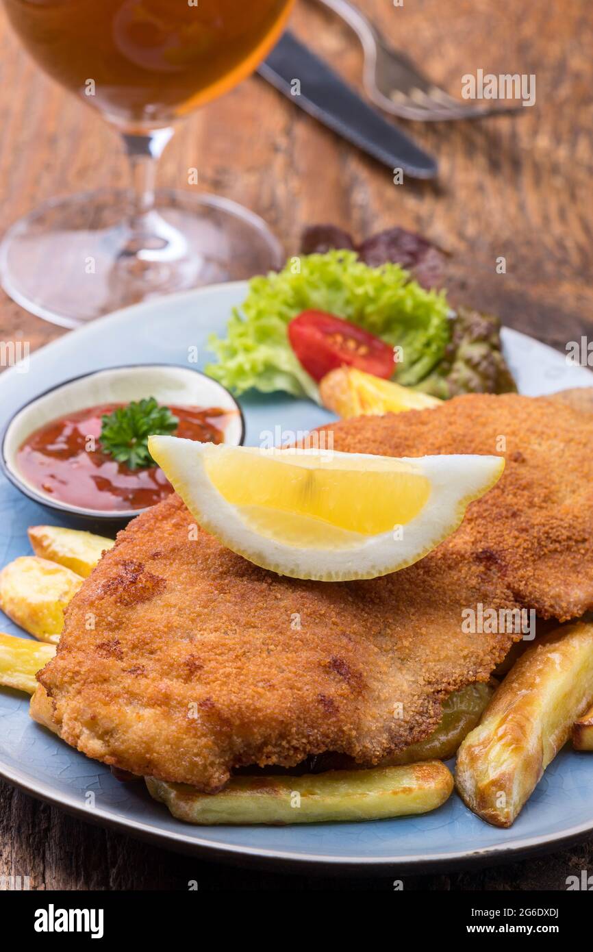 Wiener schnitzel with fries on a plate hi-res stock photography and ...
