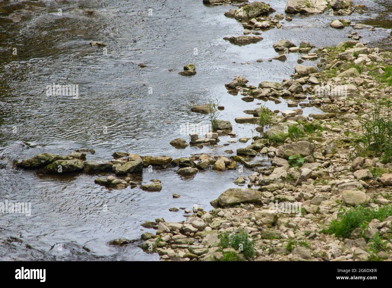 Small creek with rocks Stock Photo - Alamy