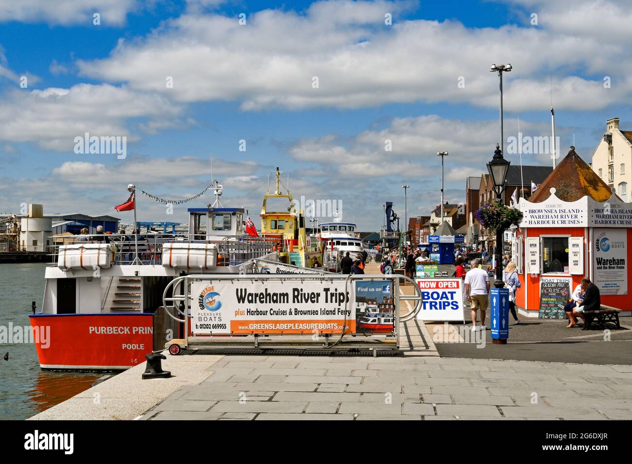 Poole, England - June 2021: Signs for boat trips and a ticket kiosk on ...