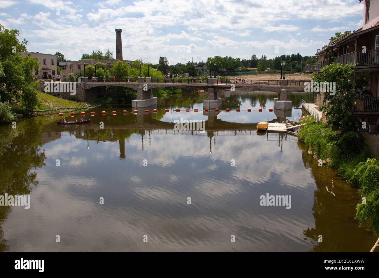 Bridge over a still river Stock Photo - Alamy