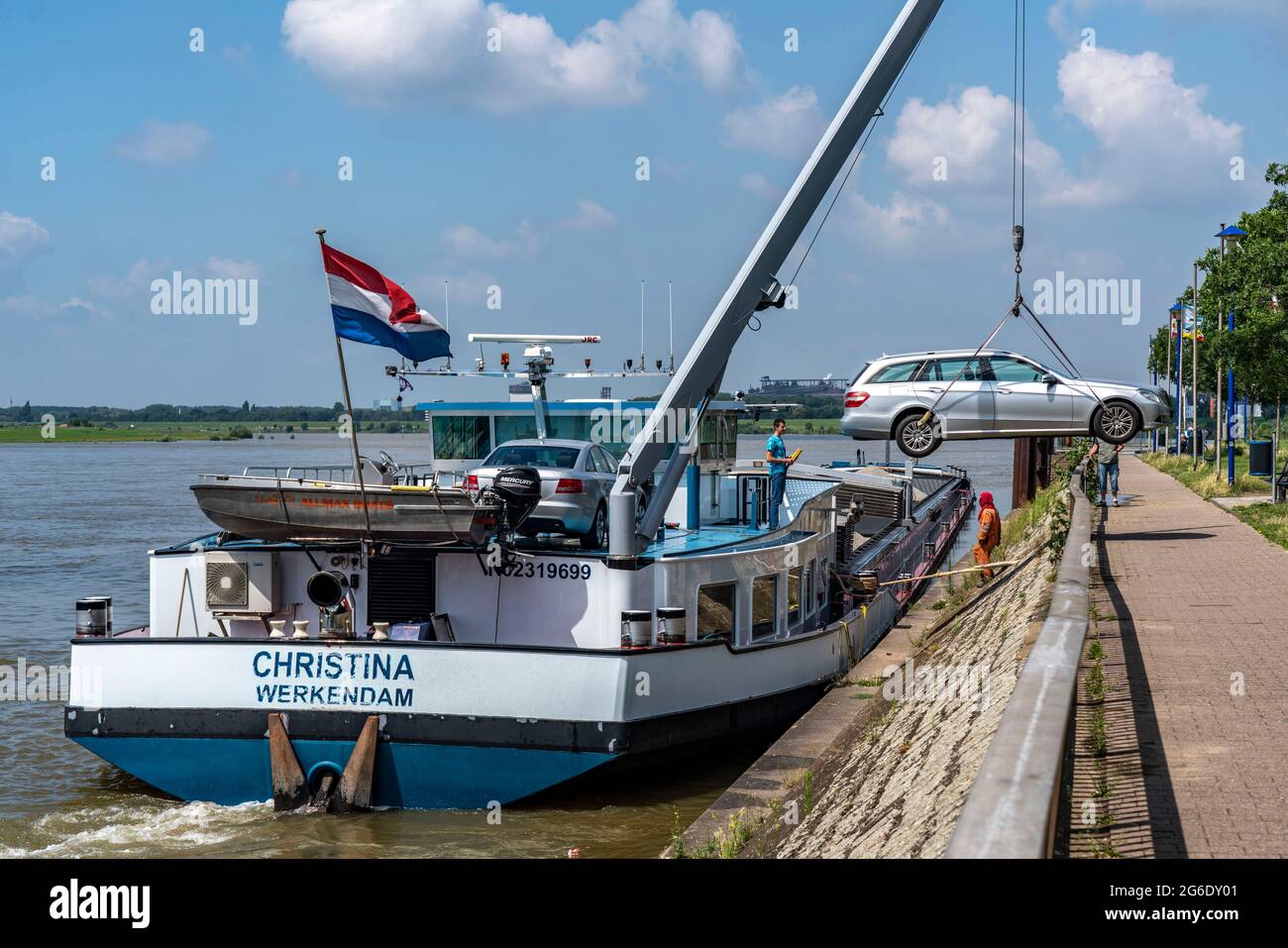 Inland navigation, vehicle of a bargeman is loaded from the shore onto ...