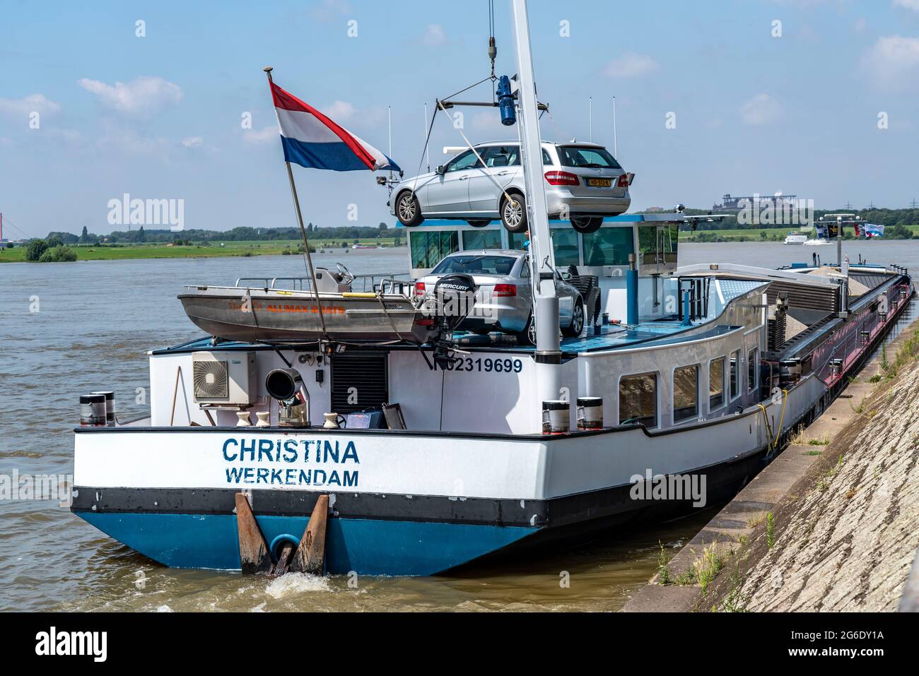 Inland navigation, vehicle of a bargeman is loaded from the shore onto ...