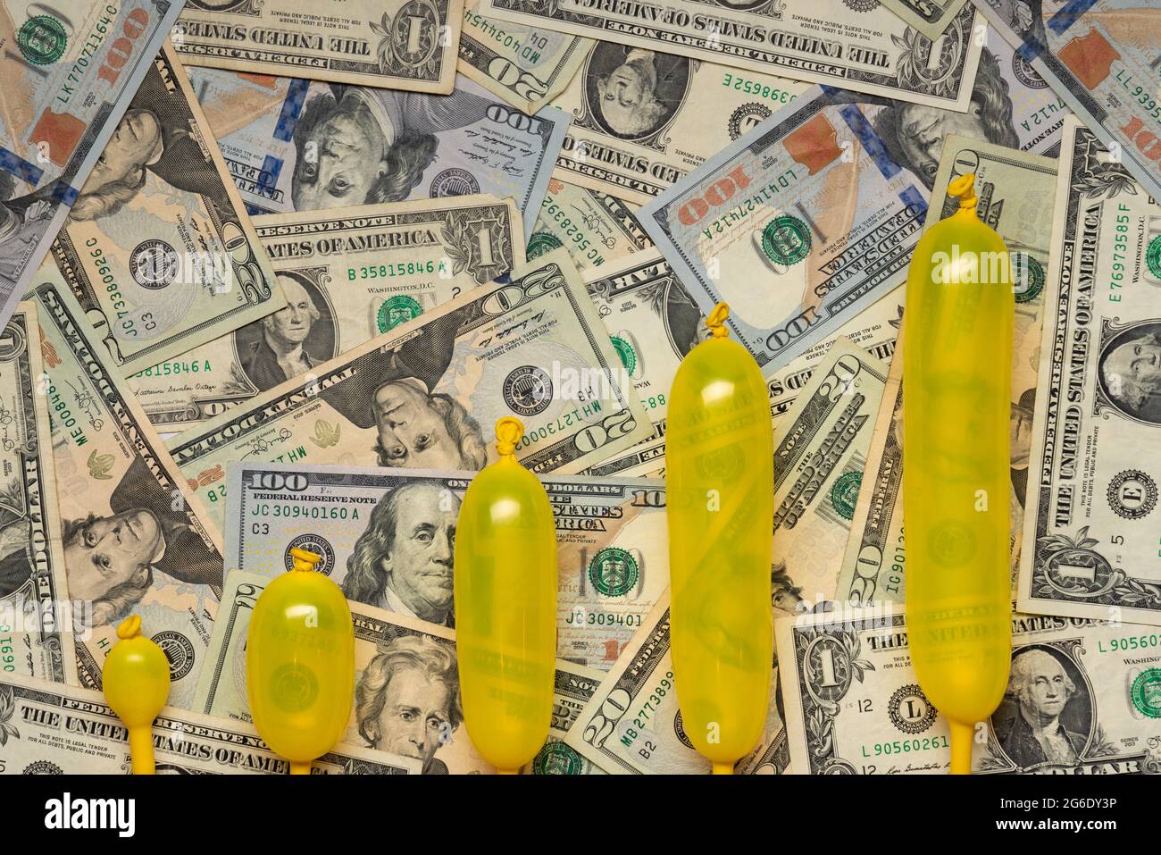 inflation concept with yellow balloons inflated to varying amounts on a ...