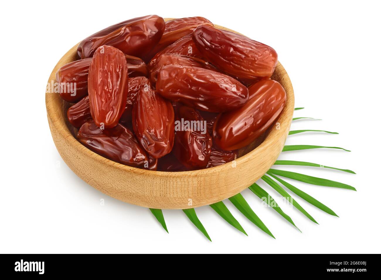 Dates in wooden bowl isolated on white background with clipping path ...