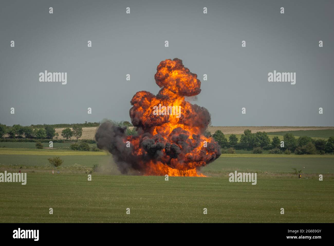 A large explosion during daylight in a field Stock Photo - Alamy