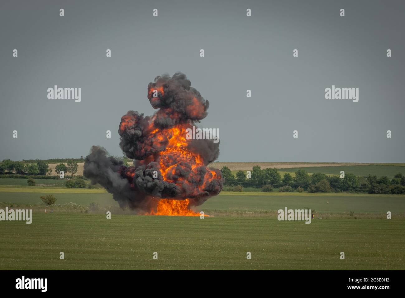 A large explosion during daylight in a field Stock Photo - Alamy