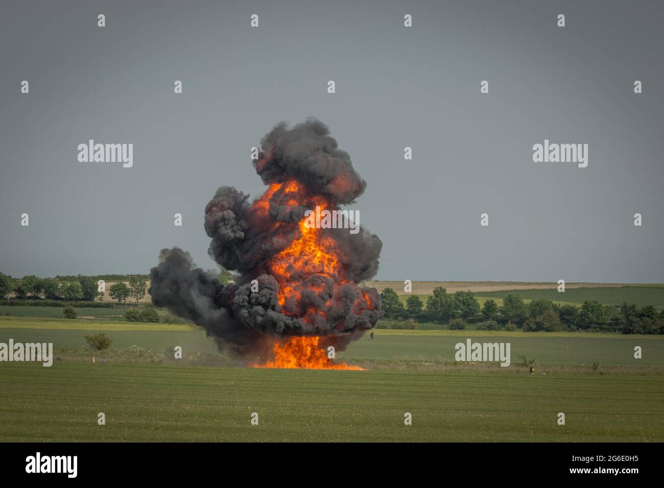 A large explosion during daylight in a field Stock Photo - Alamy