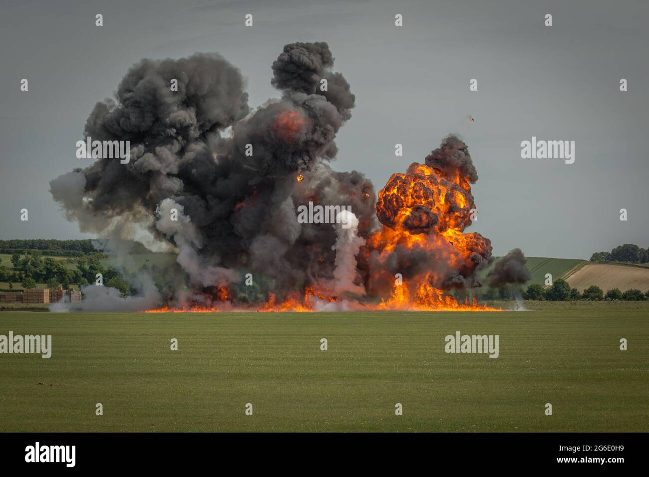A large explosion during daylight in a field Stock Photo - Alamy