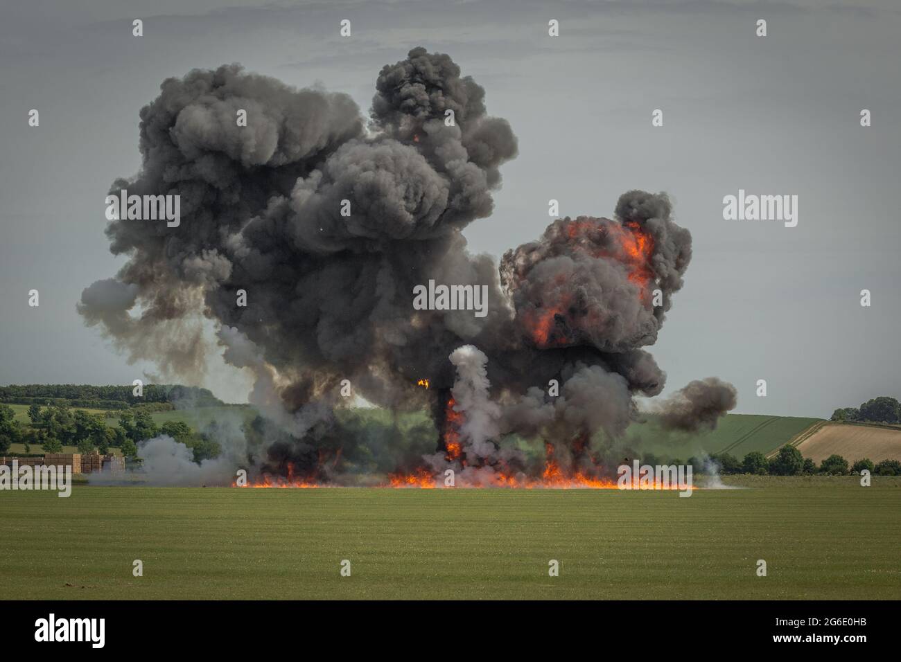 A large explosion during daylight in a field Stock Photo - Alamy